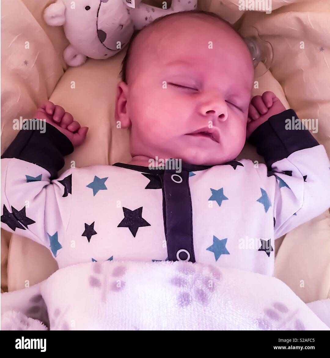My baby Jonathan asleep in his Moses basket. He is wearing his star ...