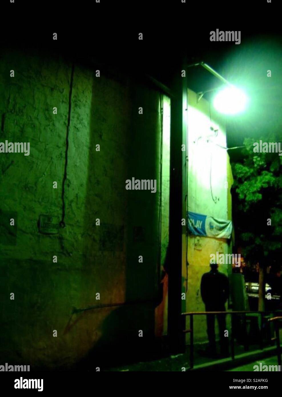 Man standing under street light hi-res stock photography and images - Alamy