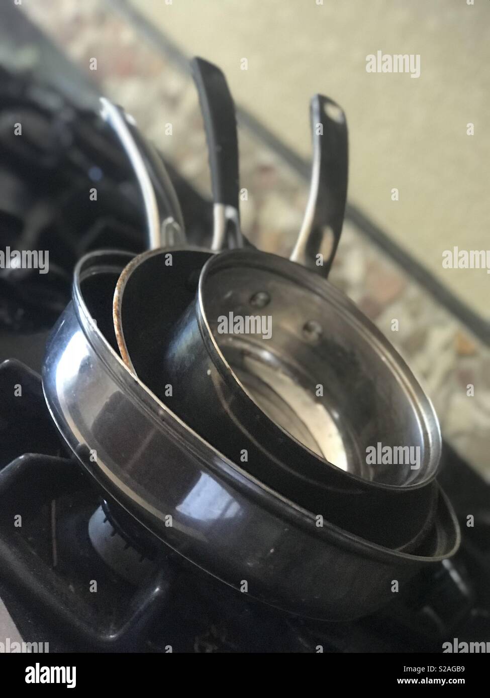 A shiny stack of pots stacks up on the stove Stock Photo - Alamy