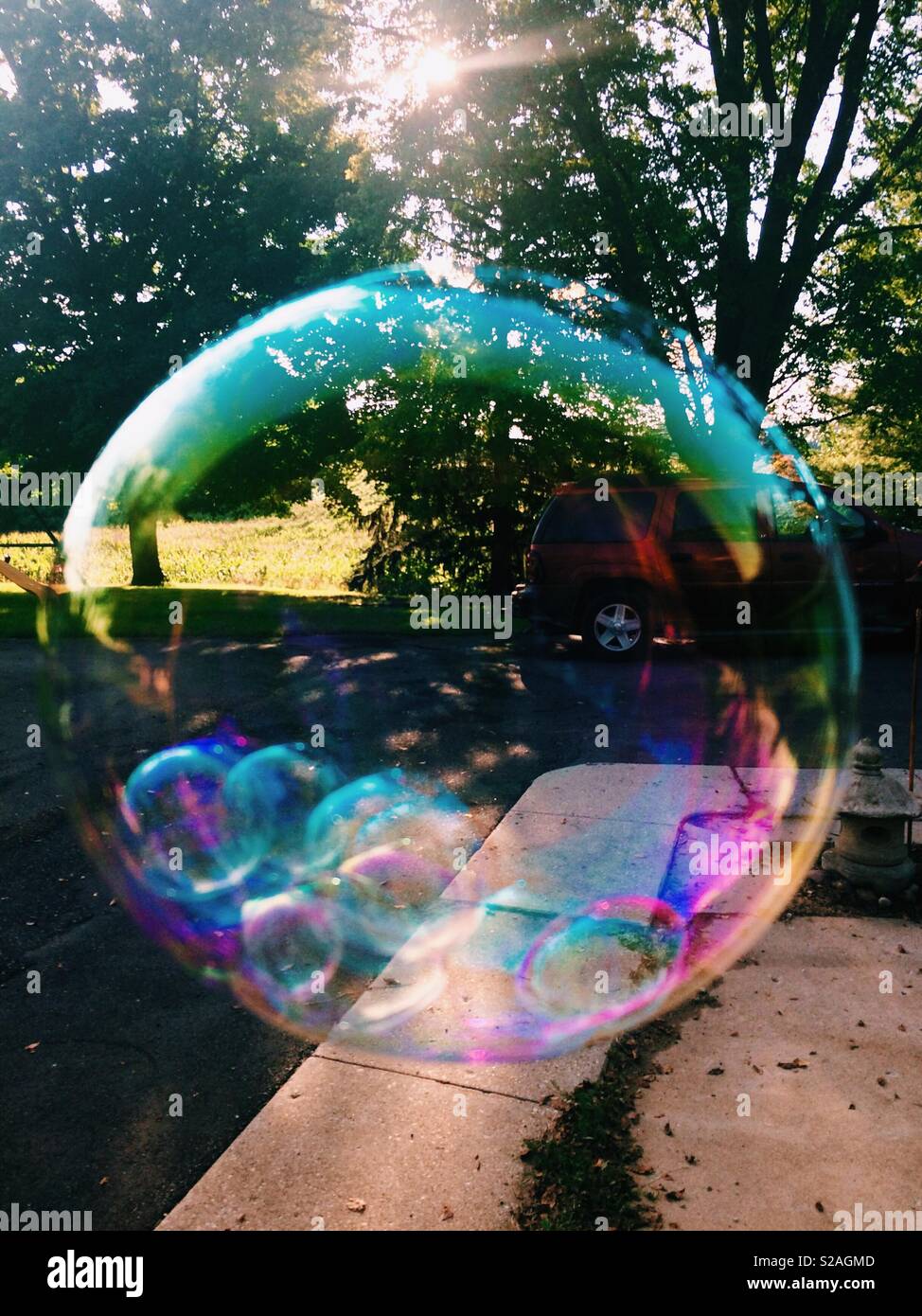 Bubble floating with sun flare Stock Photo - Alamy