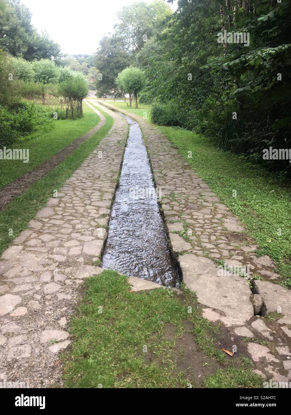 Water feature in a country path Stock Photo - Alamy