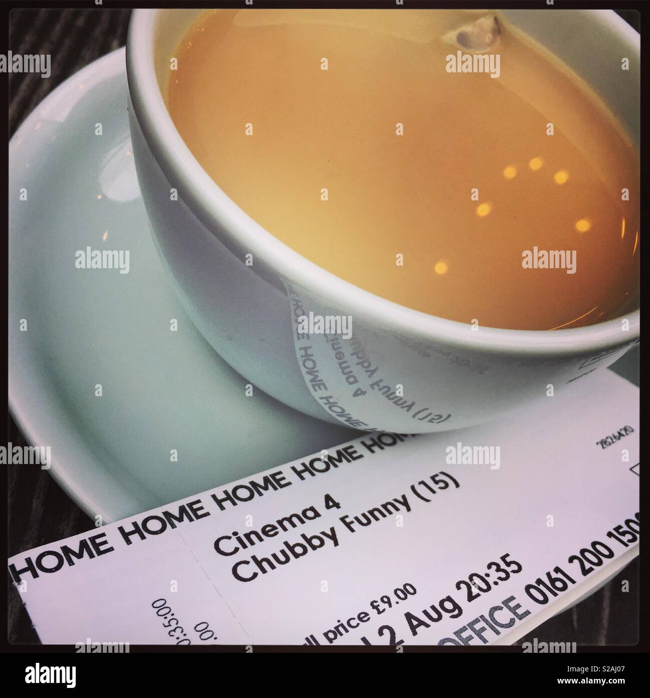 Cup of tea & cinema ticket Stock Photo - Alamy