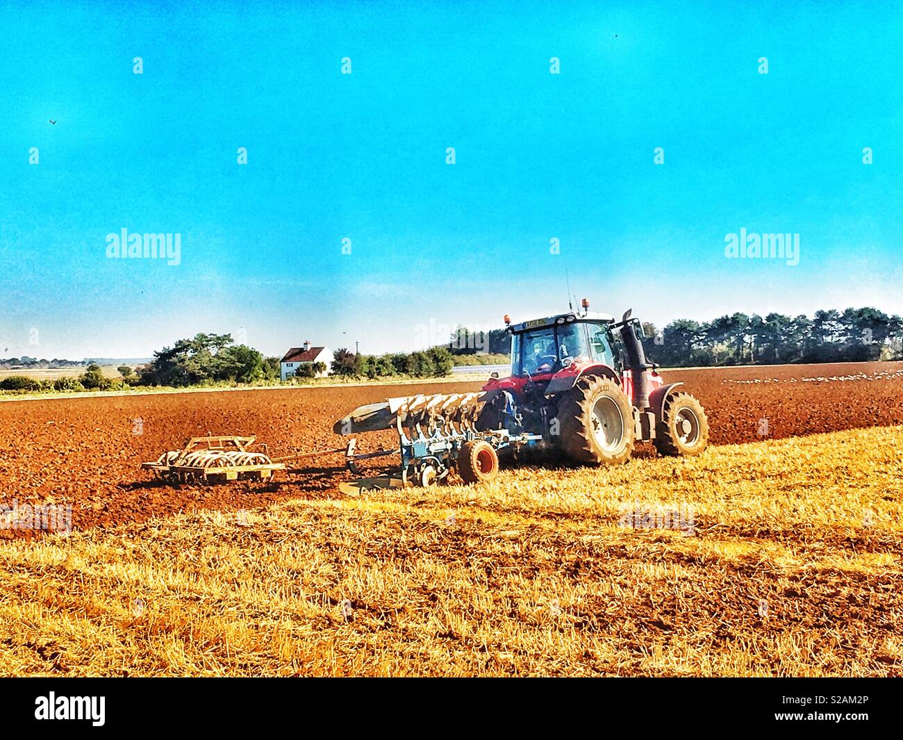 Tractor and plough, Bawdsey, Suffolk, England Stock Photo - Alamy