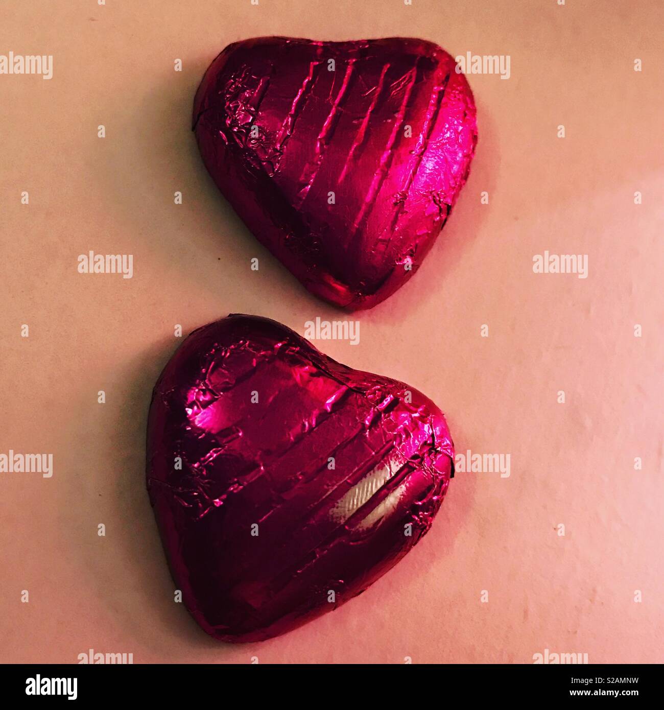 Two heart shaped chocolates Stock Photo - Alamy