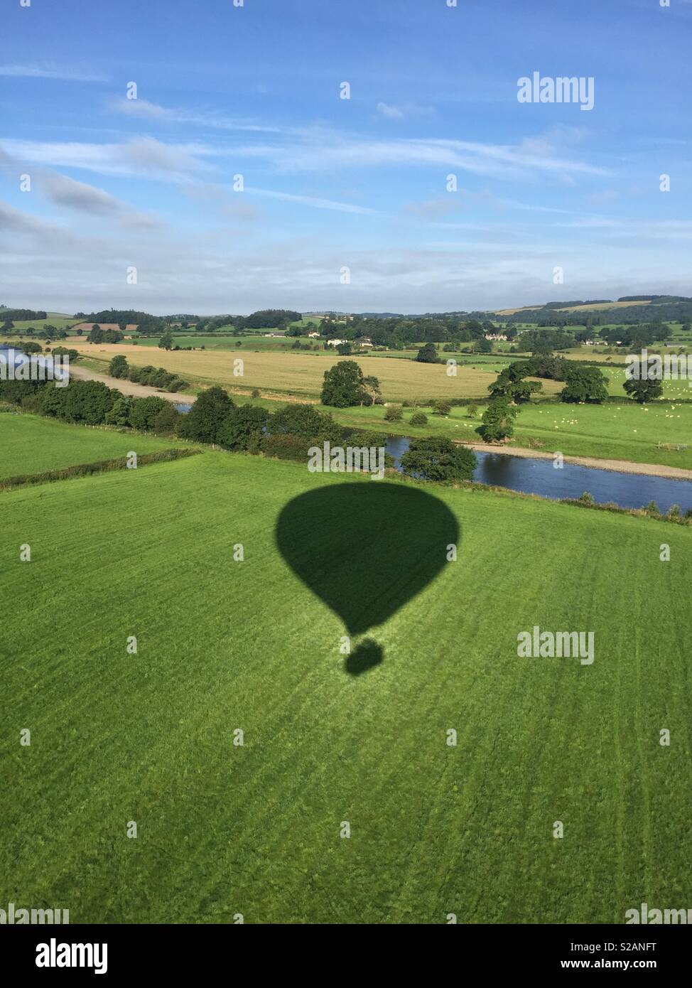 Hot air balloon shadow in field Stock Photo - Alamy