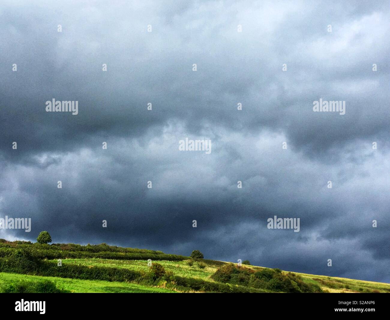 Dark clouds over field hi-res stock photography and images - Alamy
