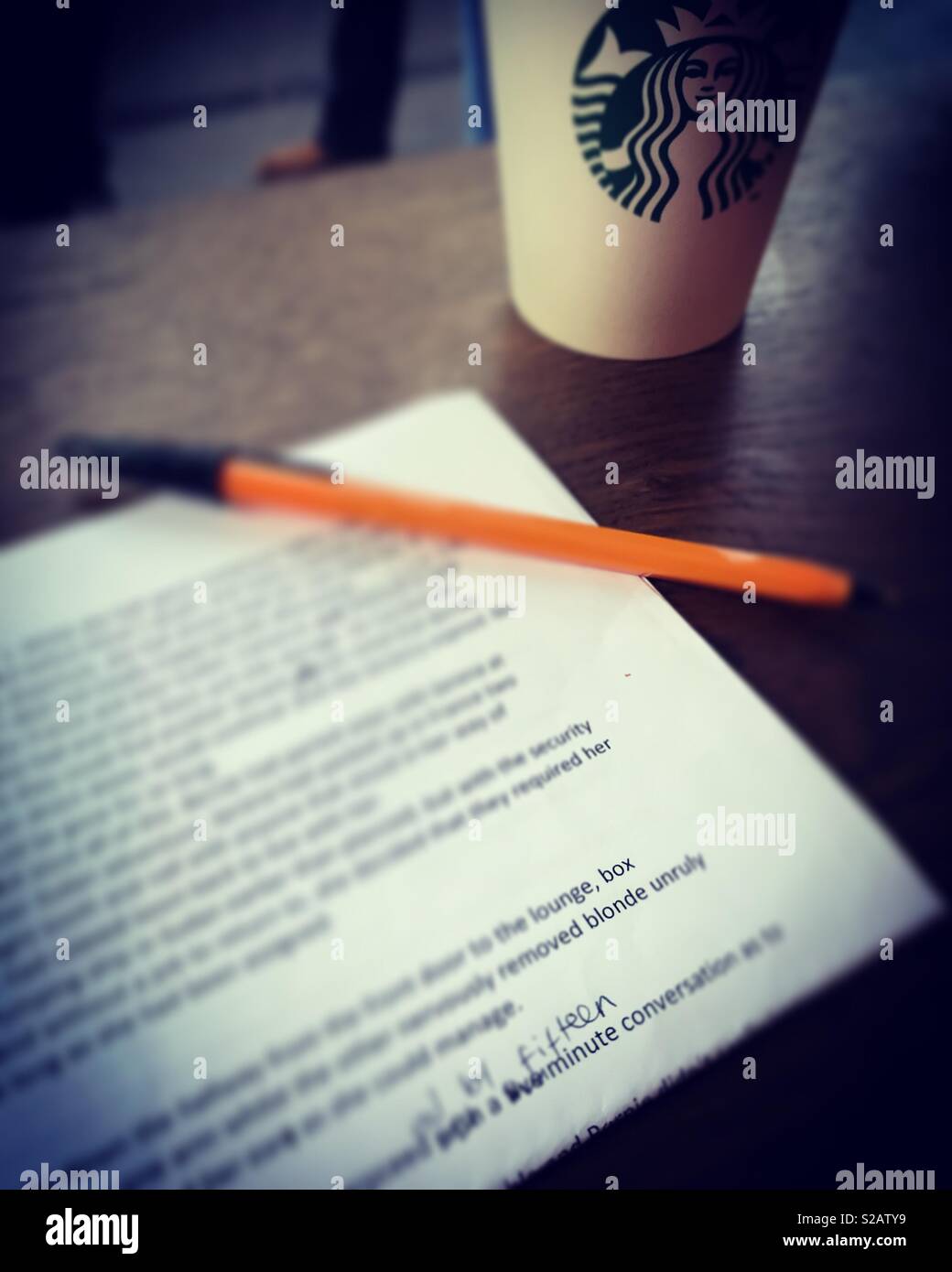 Editing text with a Starbucks Stock Photo - Alamy