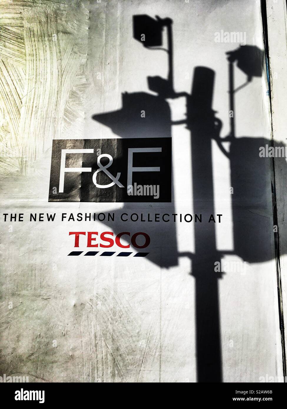 Traffic light shadows over a Tesco advert on a billboard in East ...