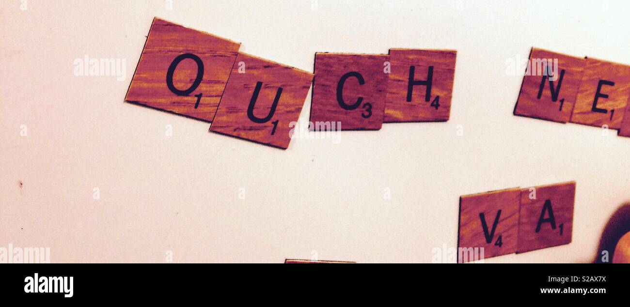The word ouch written in magnetic letters with scores for each on a ...