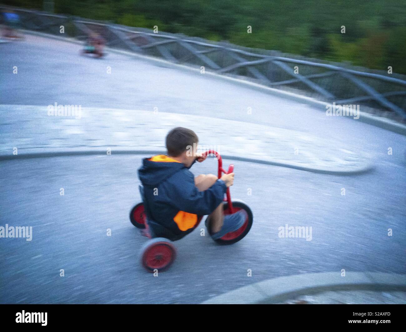 Boy riding a little three wheeler bike Stock Photo - Alamy