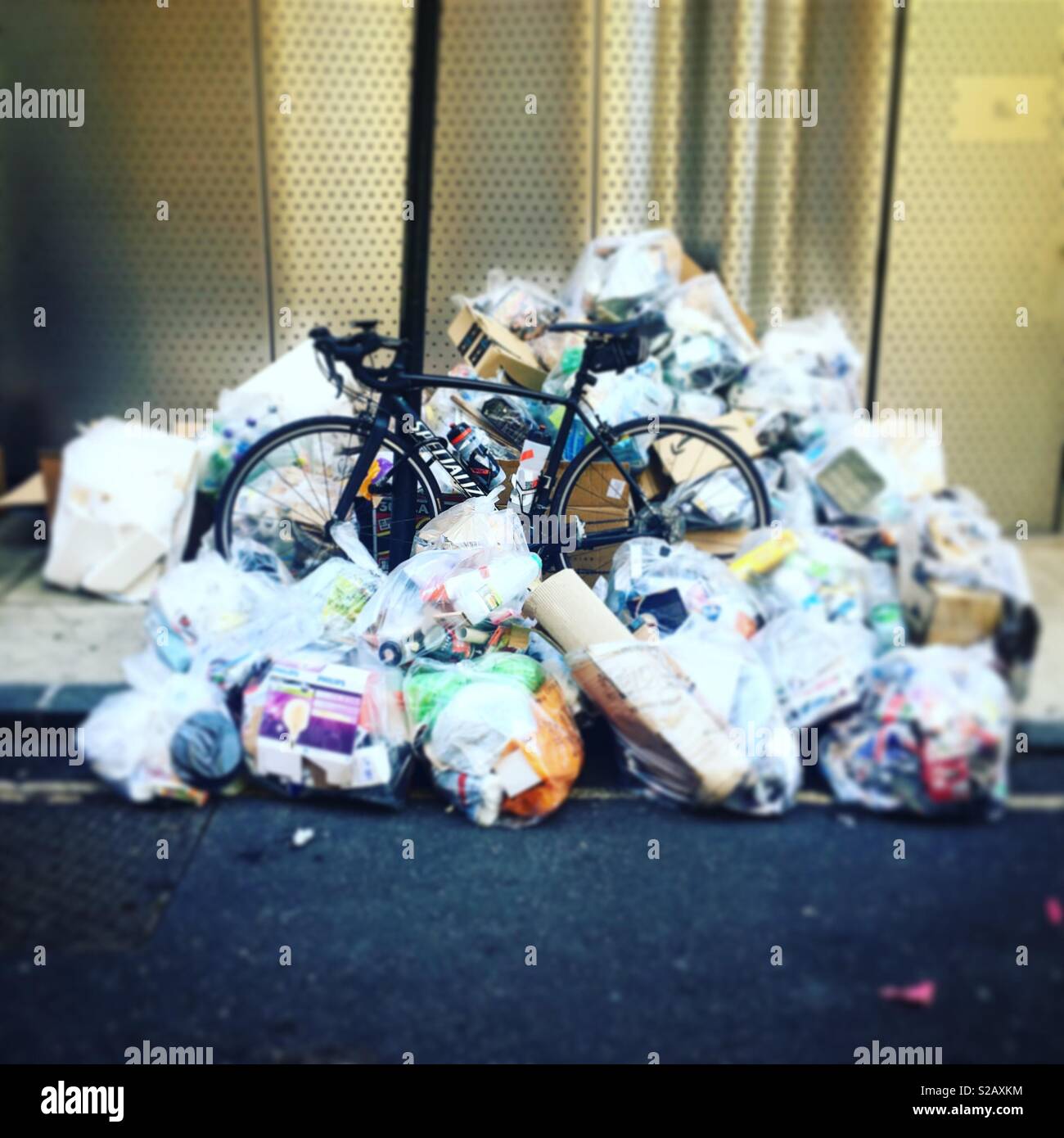 Bike parked in pile of rubbish Stock Photo - Alamy