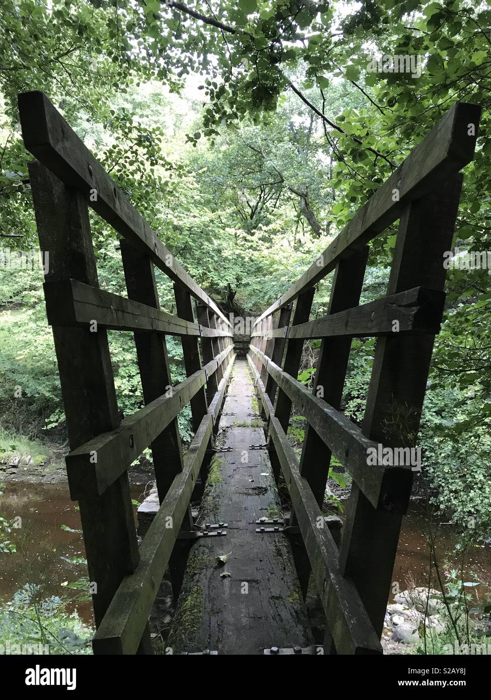 Wooden bridge over a stream Stock Photo - Alamy