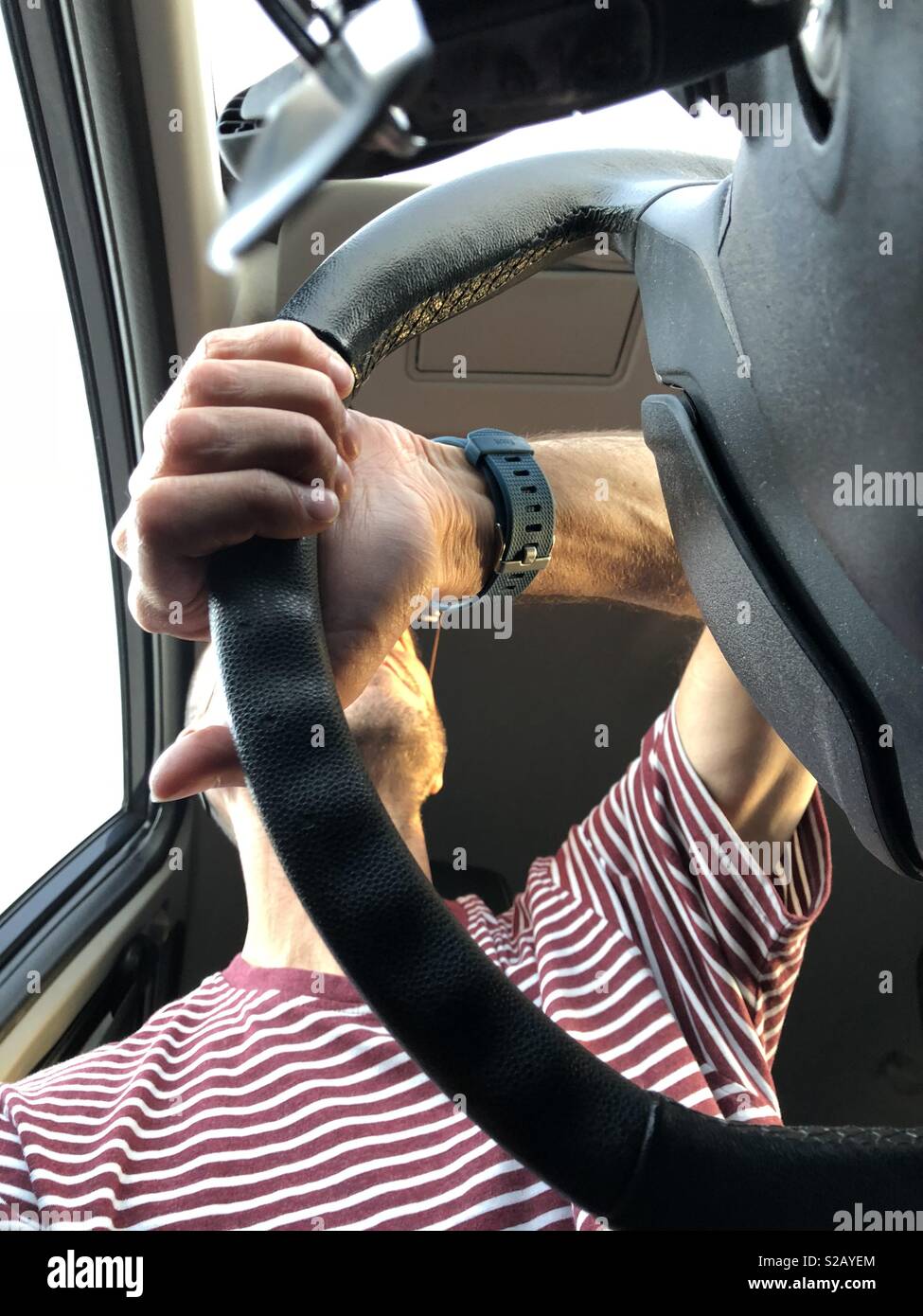 Car driver steering vehicle from low angle Stock Photo - Alamy