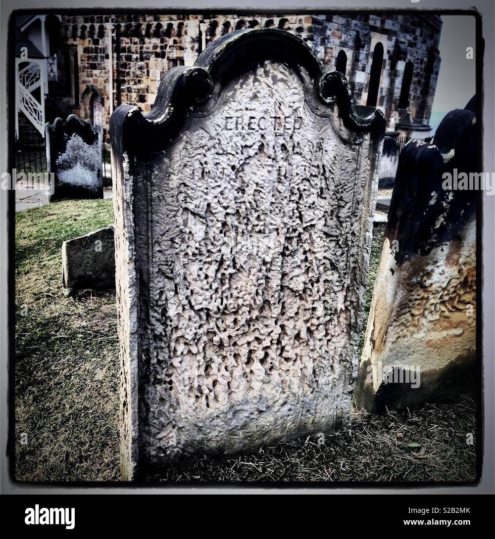 Severely eroded gravestone in Whitby Stock Photo - Alamy