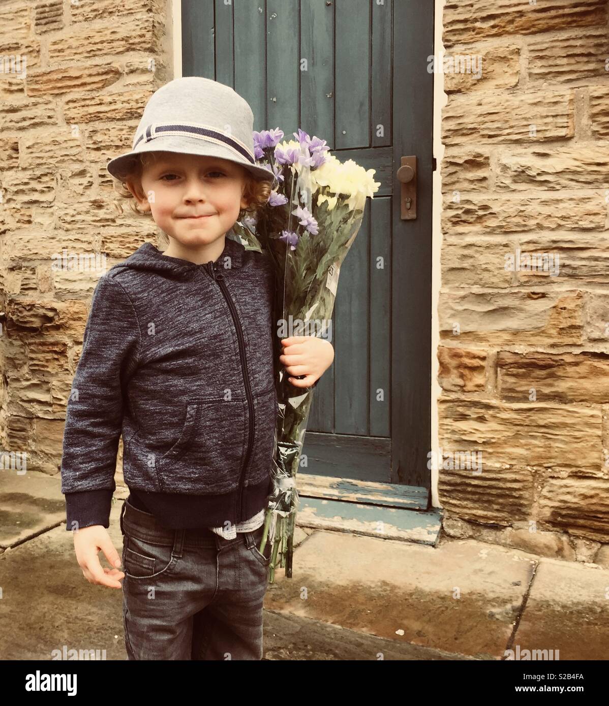Young boy with flowers Stock Photo - Alamy