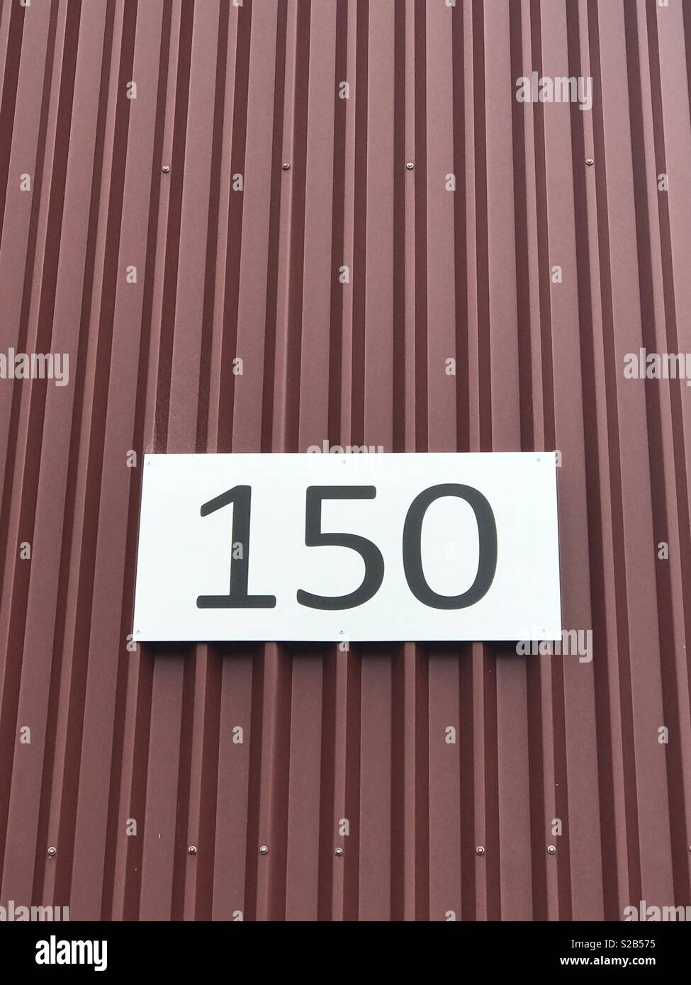 150 sign on white background with red wall Stock Photo - Alamy