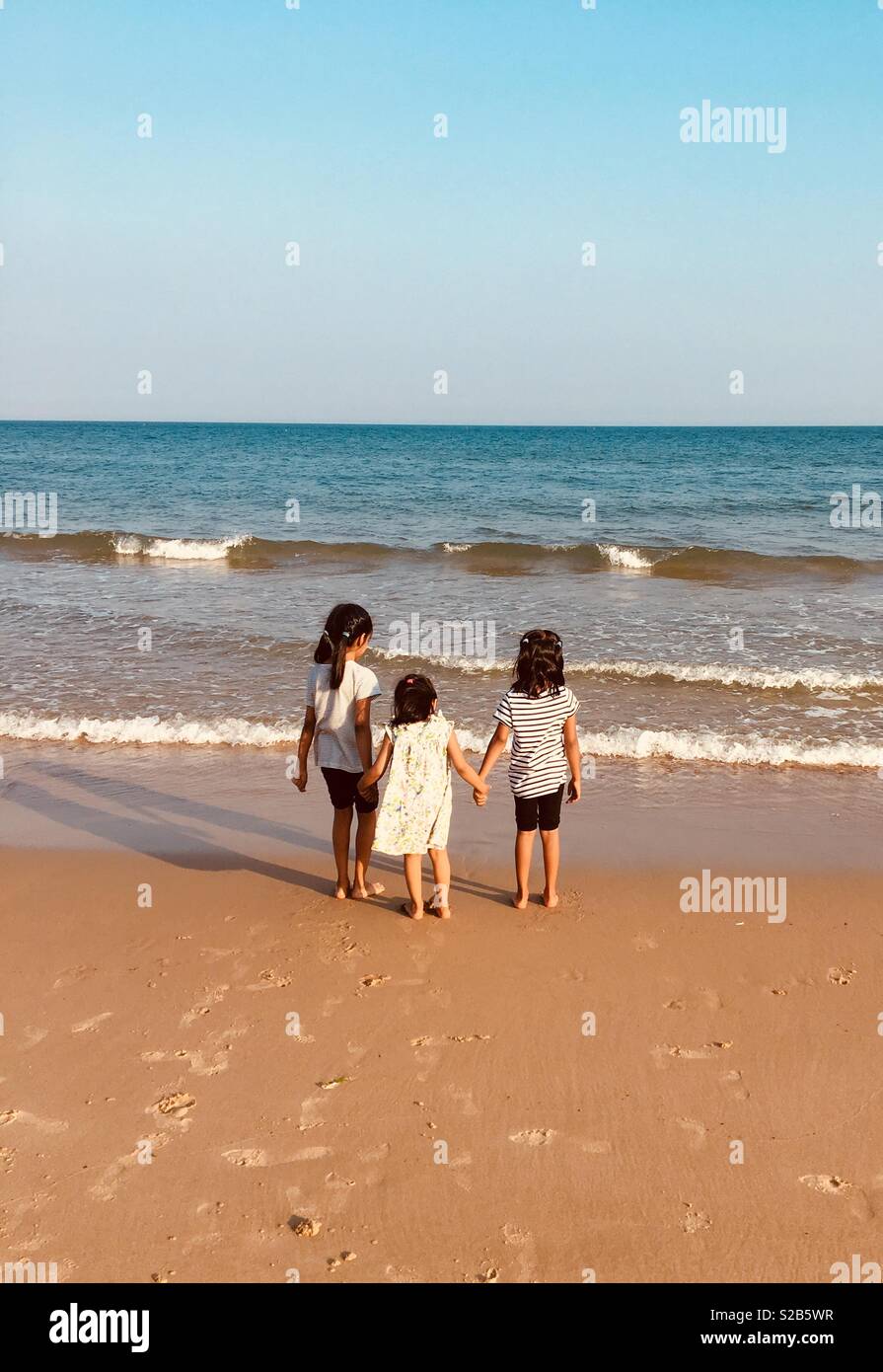Three Sisters Holding Hands