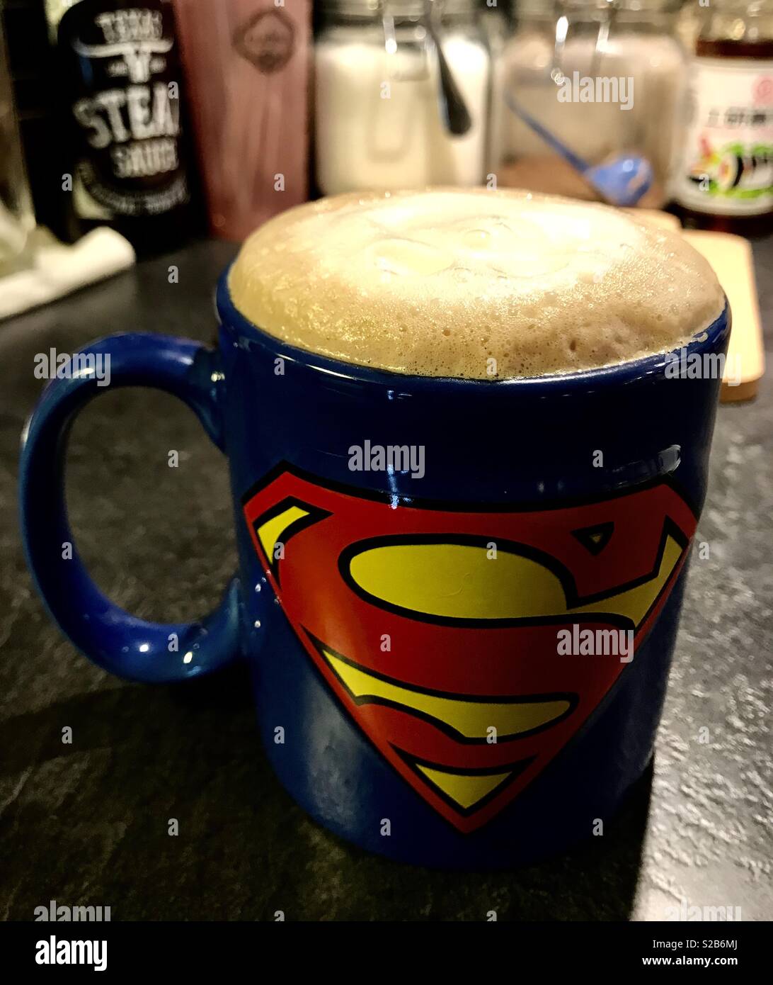 Superman coffee mug with foam Stock Photo - Alamy