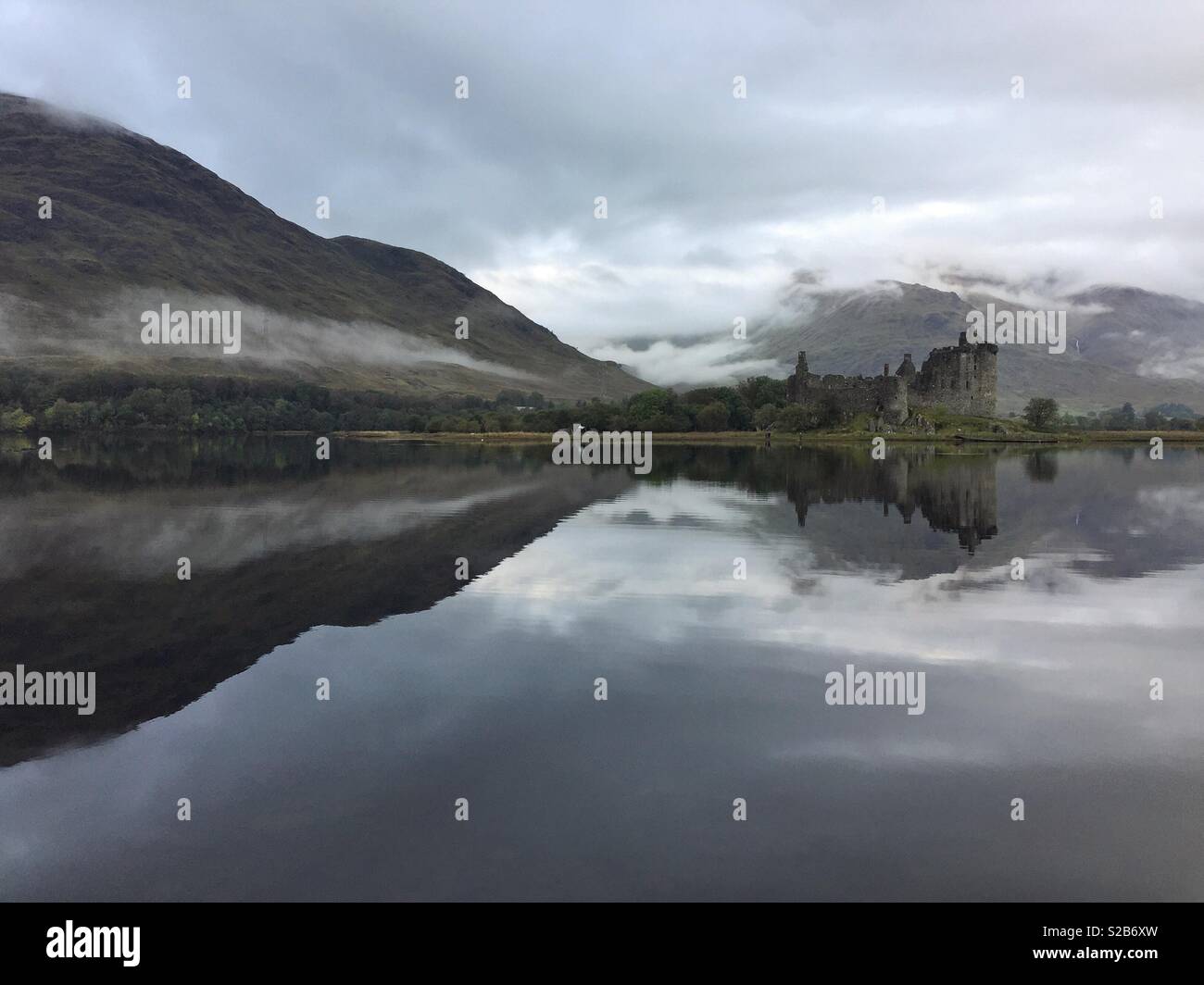 Symmetrical reflections of Kilchurn Castle by Loch Awe in Scotland ...