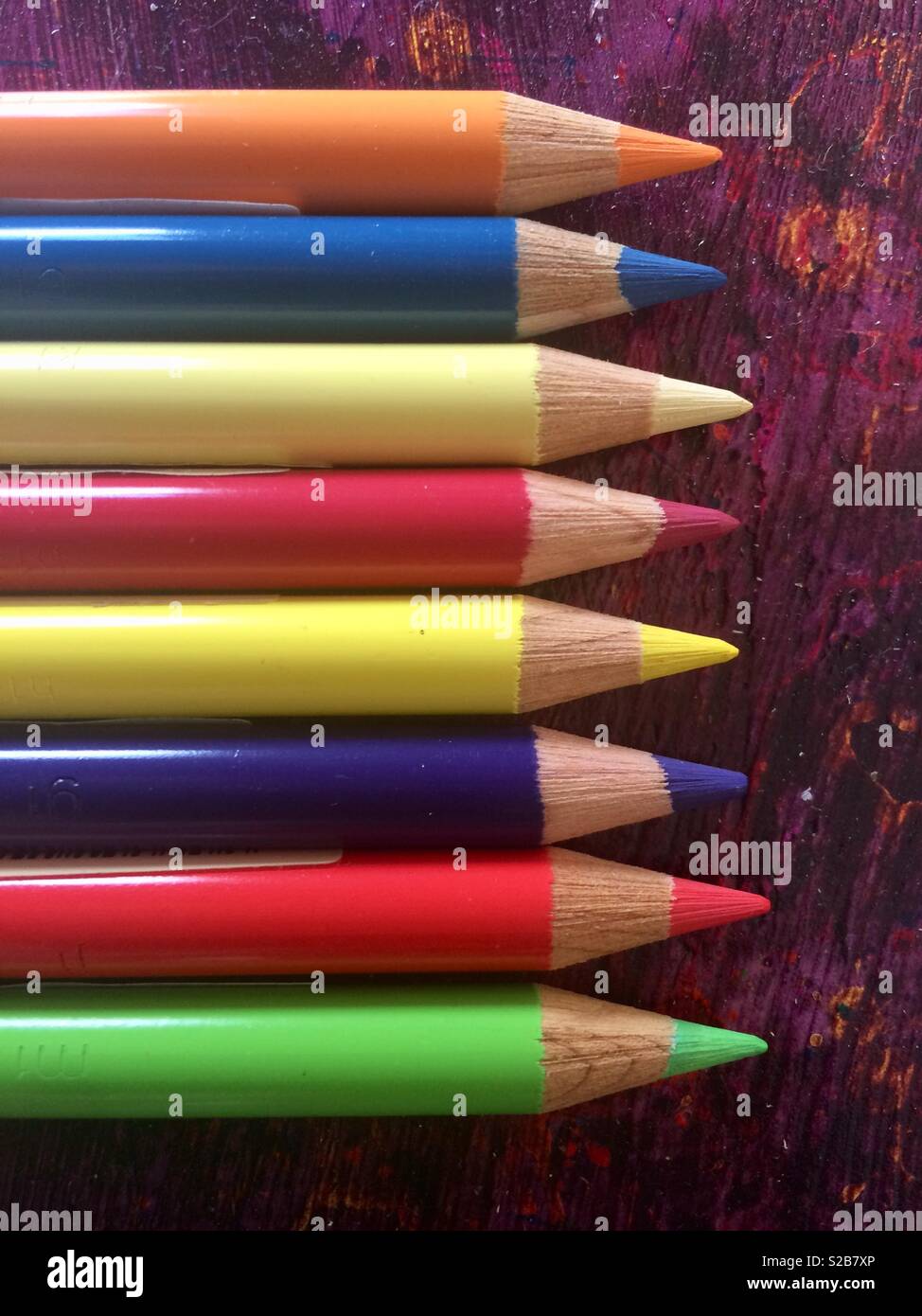Colouring pencils on a painted background Stock Photo - Alamy