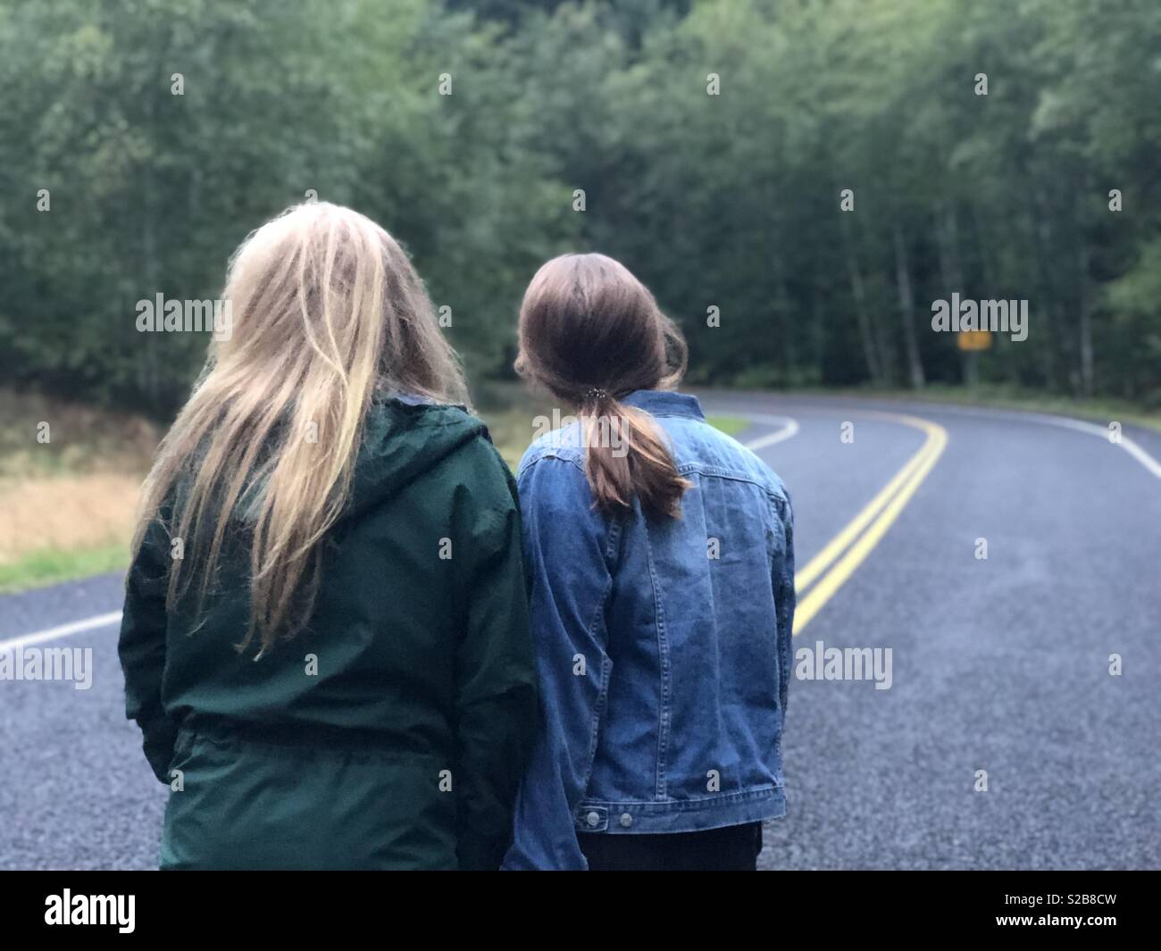 Girls standing in road Stock Photo - Alamy