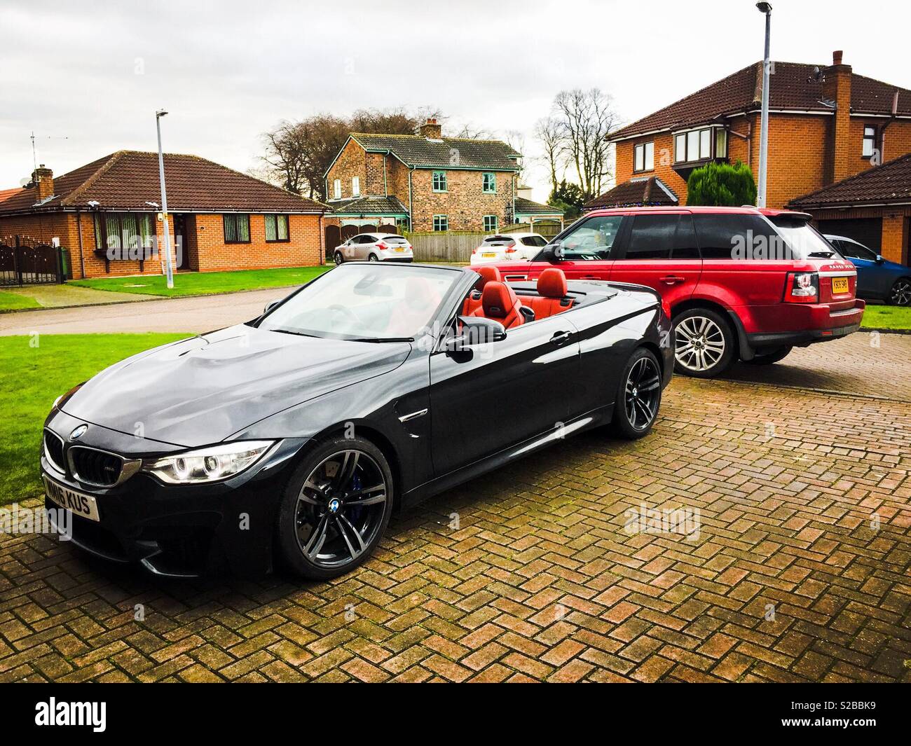 BMW M4 and Range Rover Parked in a residential driveway Stock Photo - Alamy