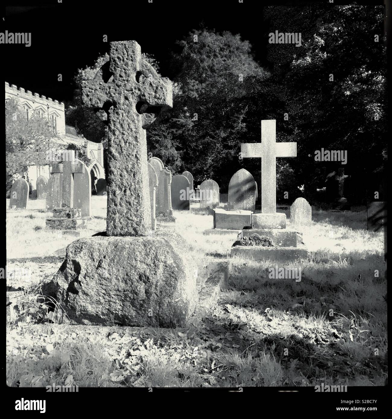 Stone cross headstones in the graveyard of St Peter’s church, North ...