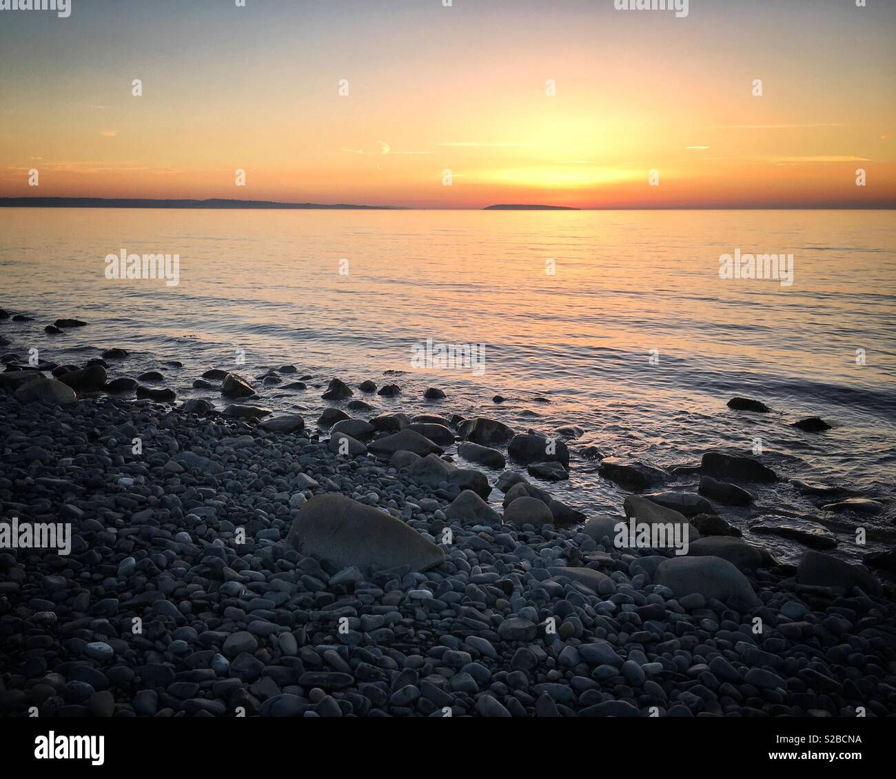 Pebble beach at sunset hi-res stock photography and images - Alamy