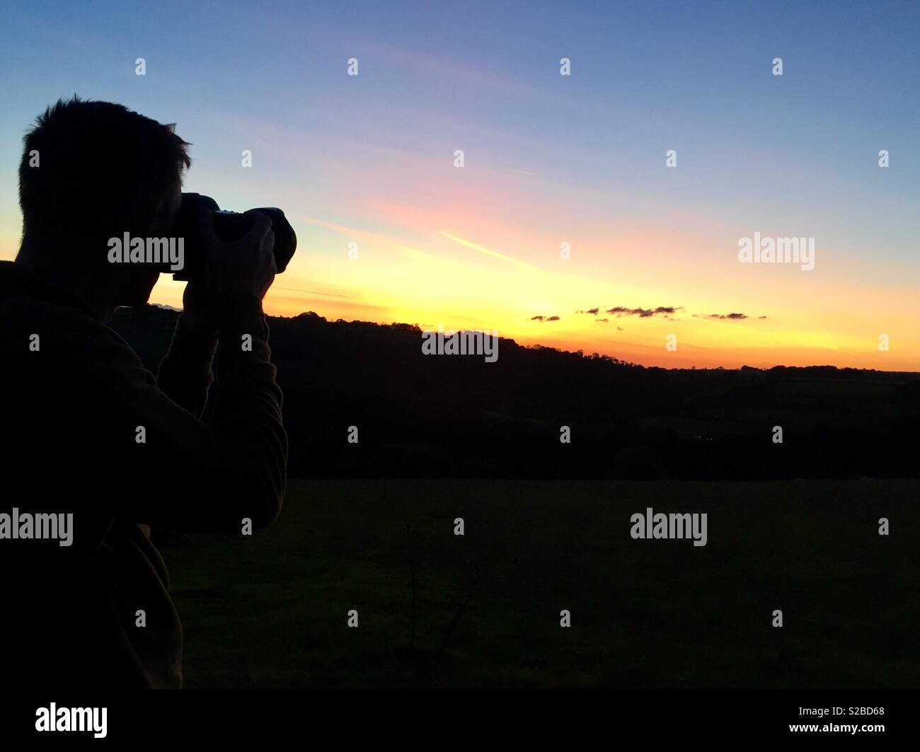 Photographer capturing a shot Stock Photo - Alamy
