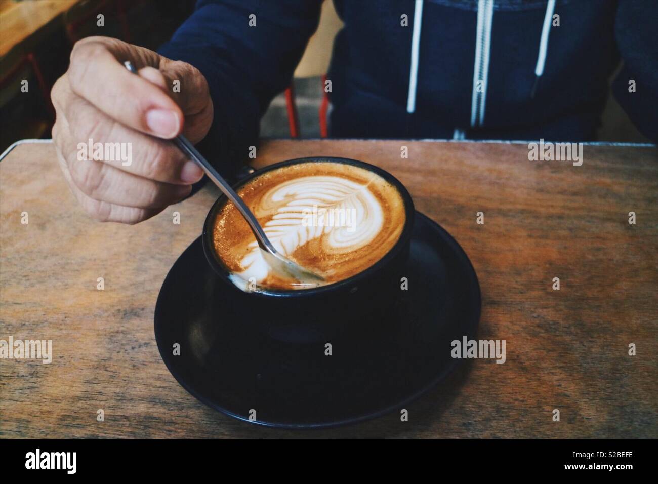 Coffee in hand Stock Photo - Alamy