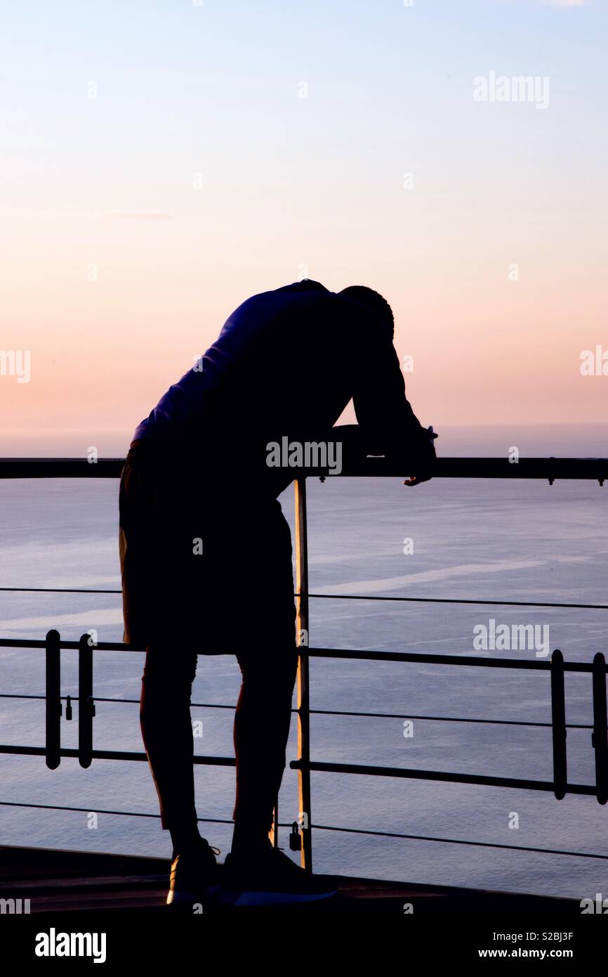 Man leaning on railing hi-res stock photography and images - Alamy