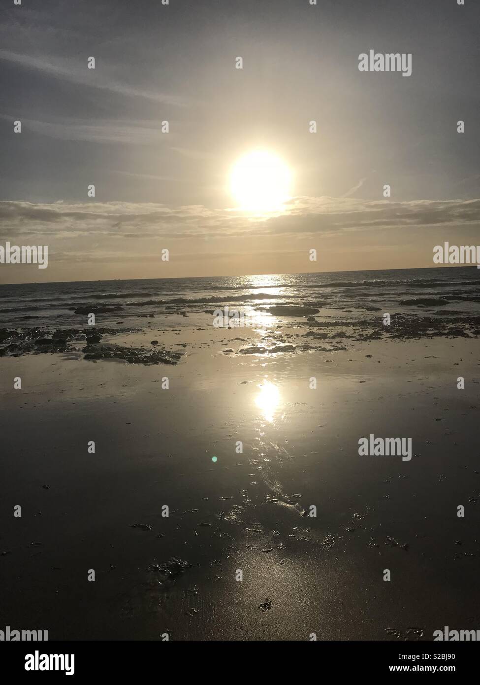 Sea sunburst, orb in sand, beach breakout, mellow seaside sky Stock ...