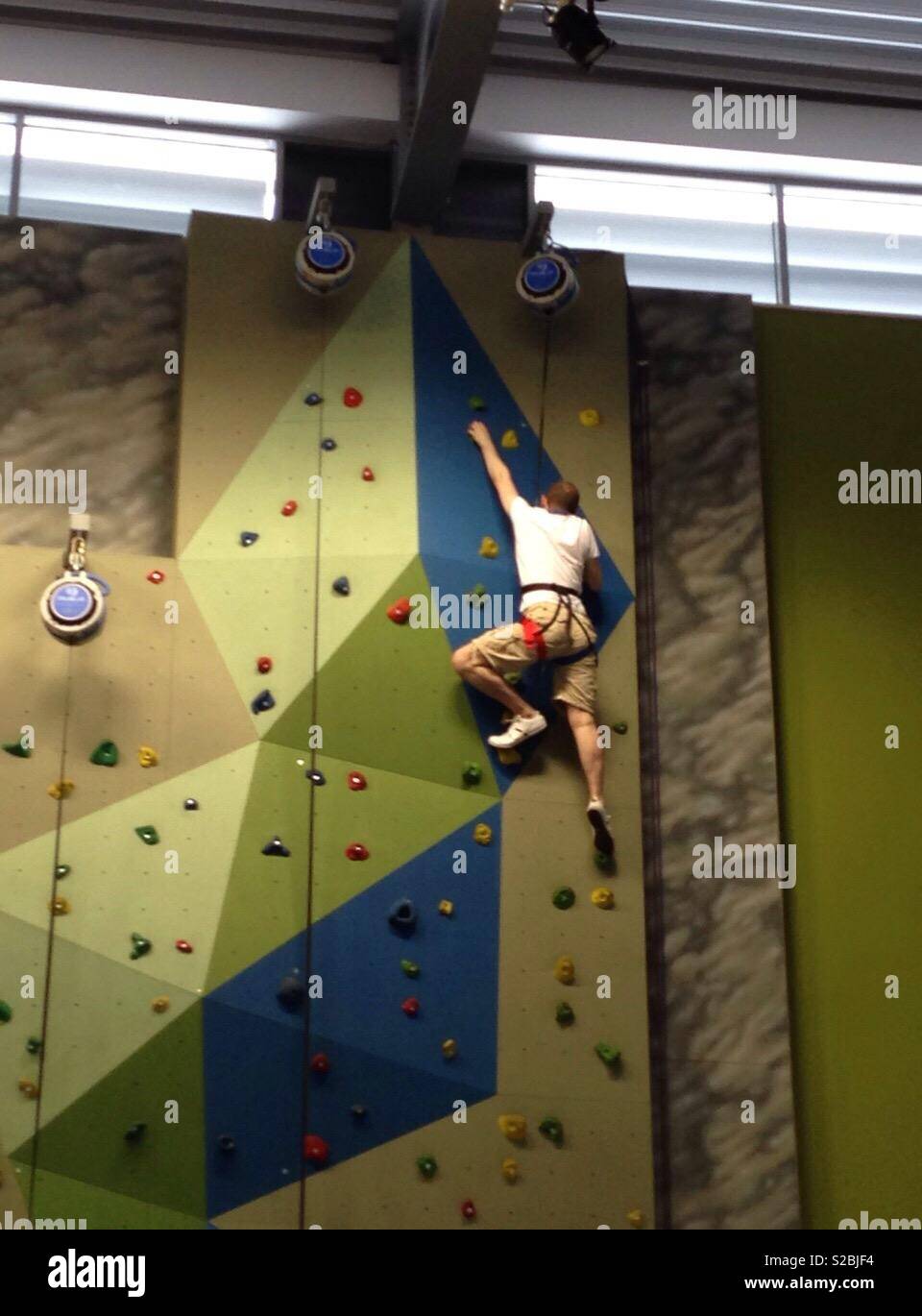 Indoor wall climbing adult Stock Photo - Alamy