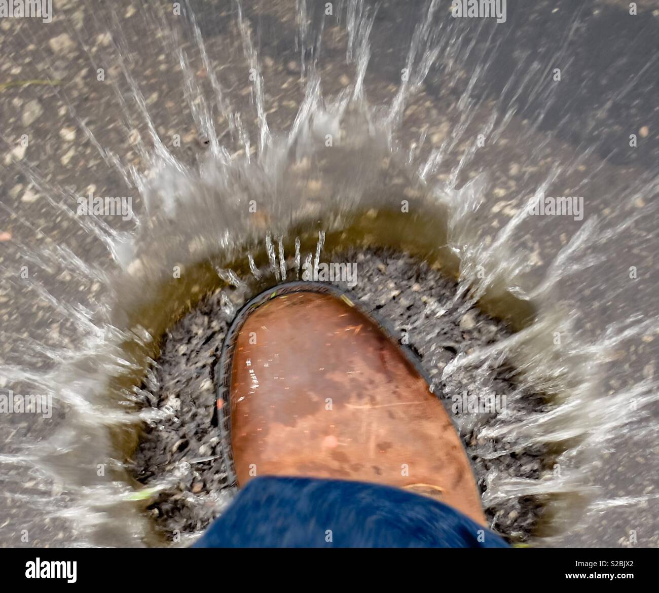 Splashing in a puddle Stock Photo - Alamy