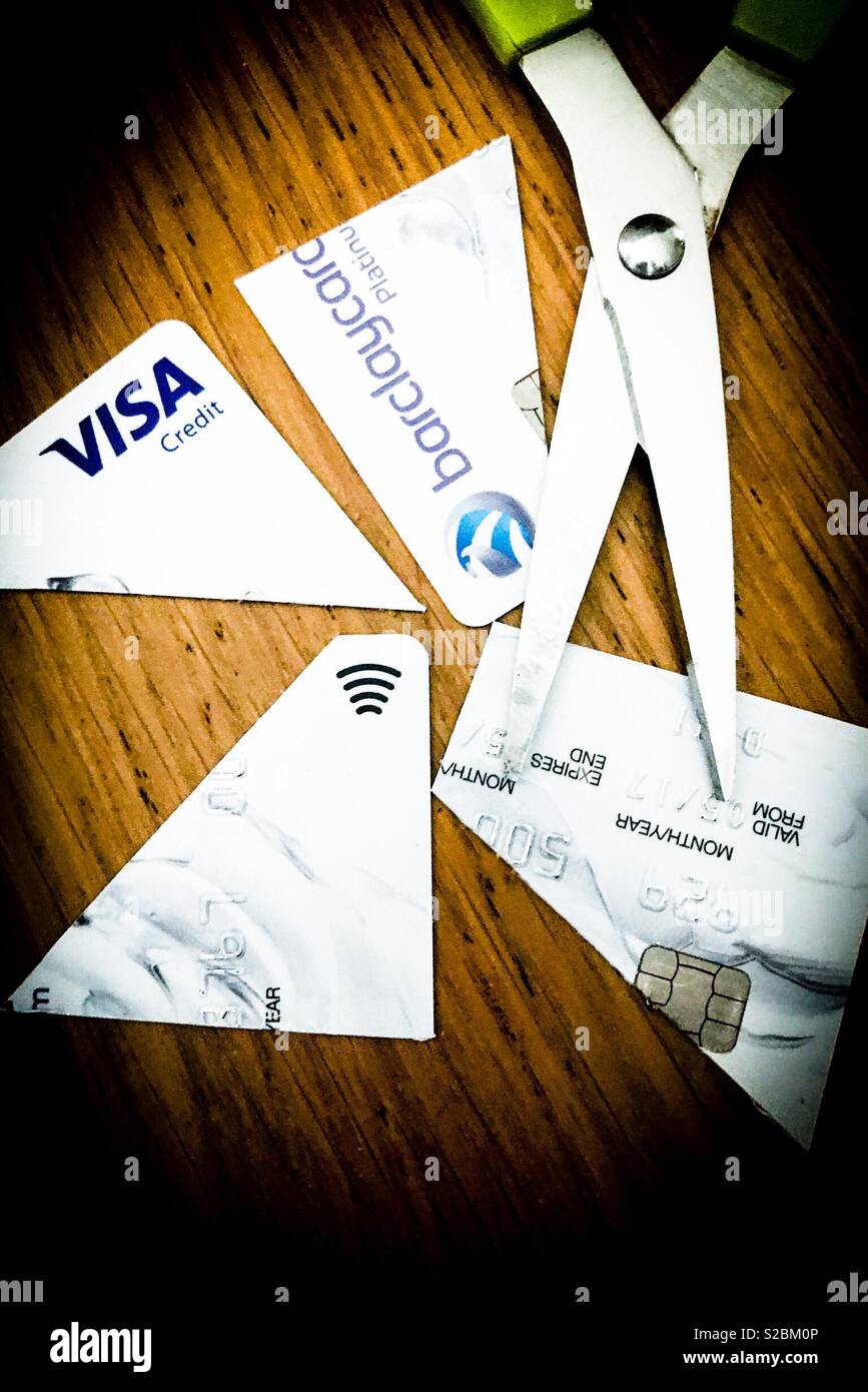 Credit card cut into pieces with scissors Stock Photo - Alamy