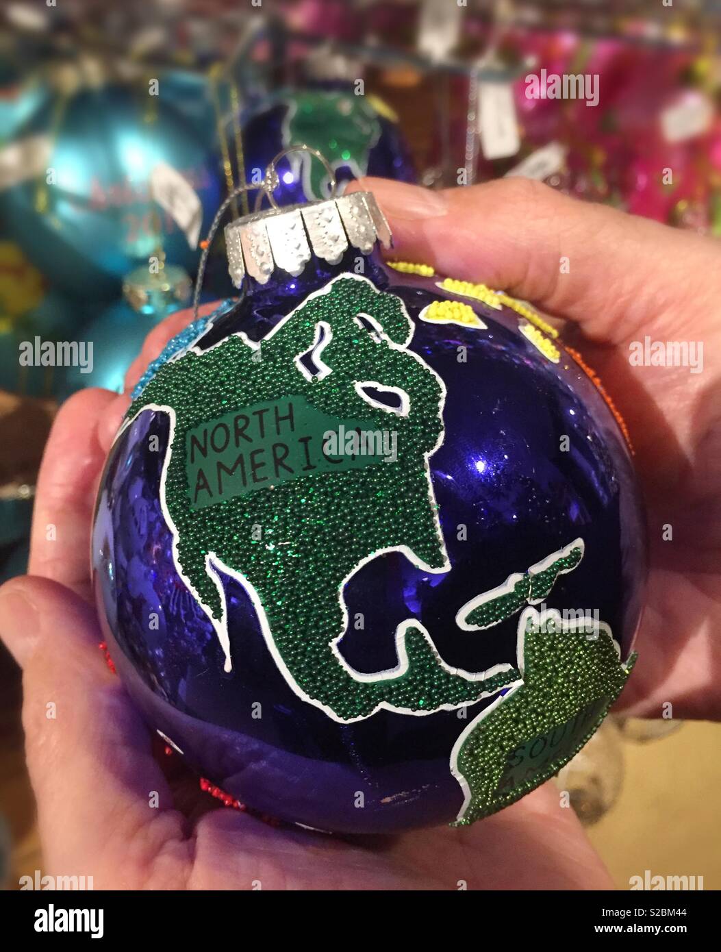 Globe map of the world ornament being held in a man’s hands, USA Stock ...