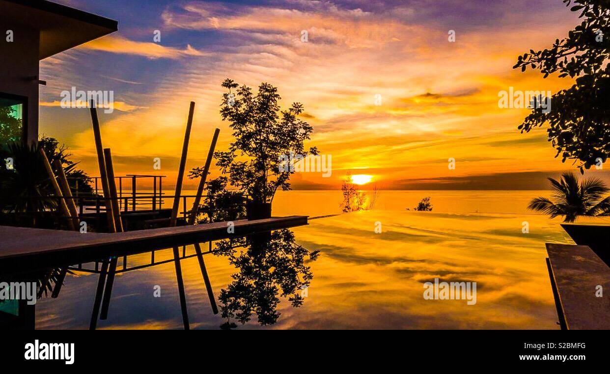 An infinity pool in Thailand at golden hour sunset Stock Photo - Alamy