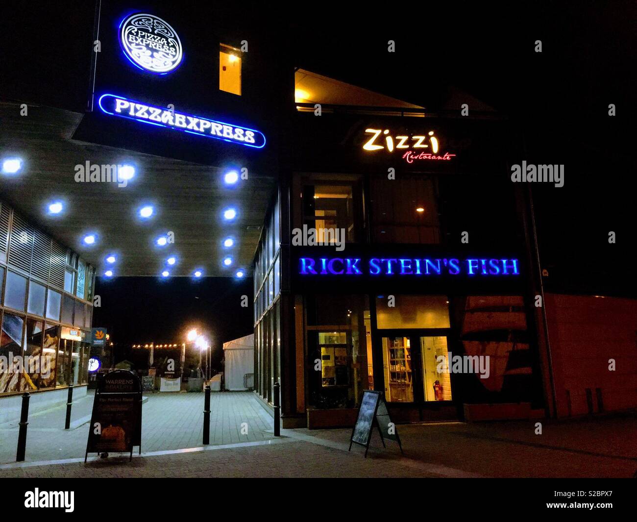 Illuminated signs for restaurants at events square in Falmouth at night ...