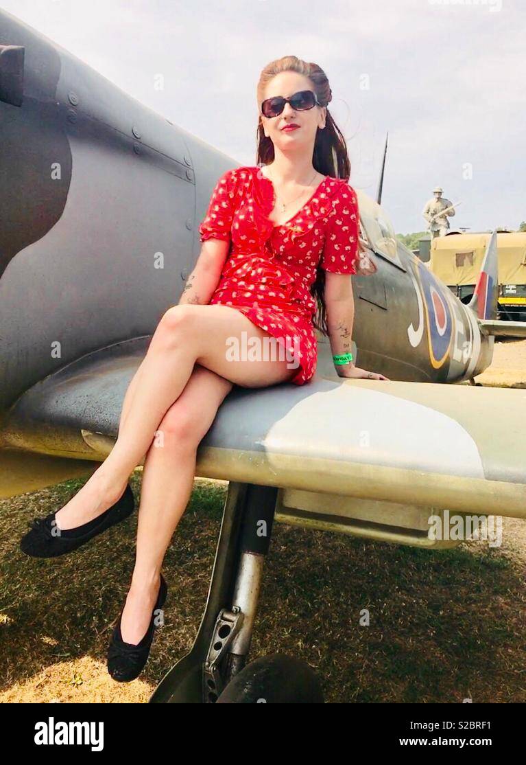 Model sitting on spitfire wing Stock Photo - Alamy