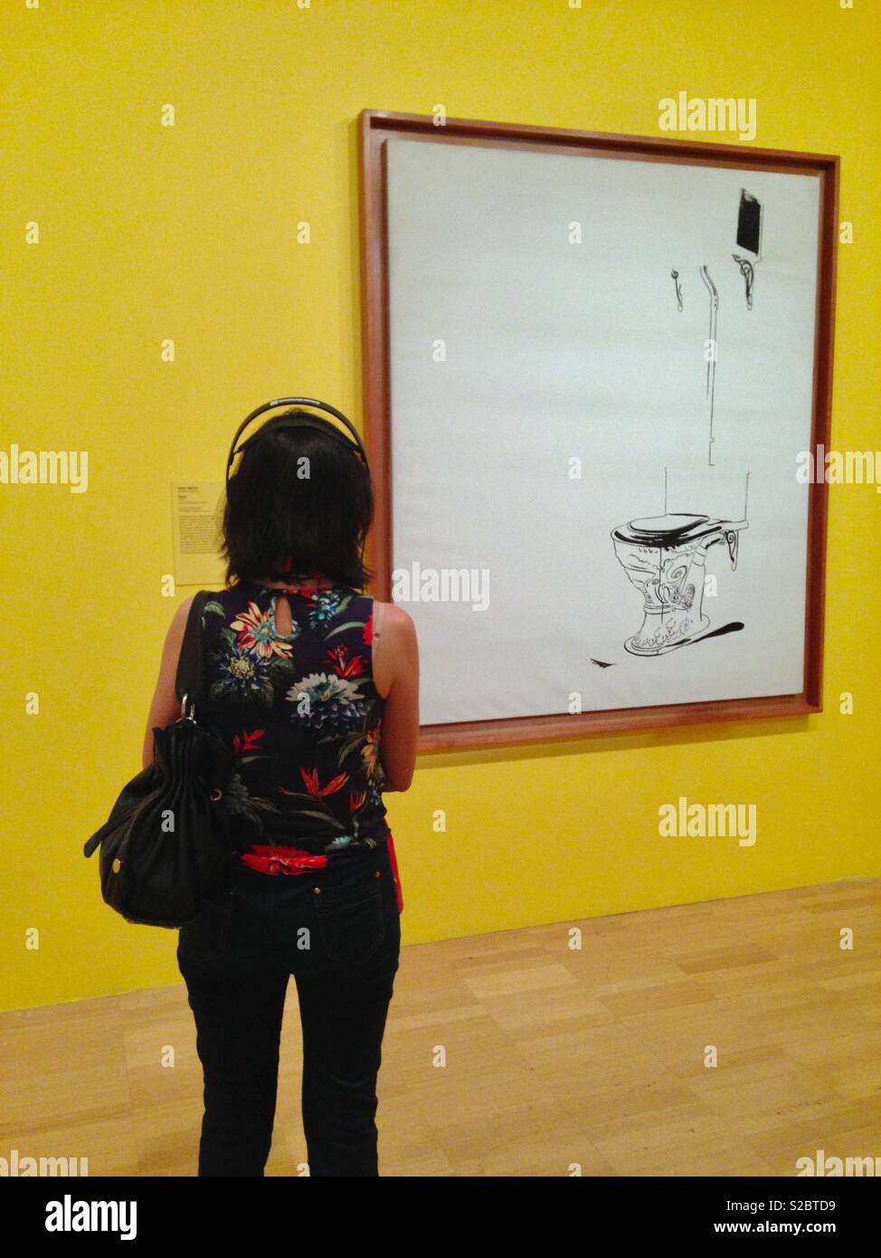 Girl contemplating some artwork in art gallery Stock Photo - Alamy