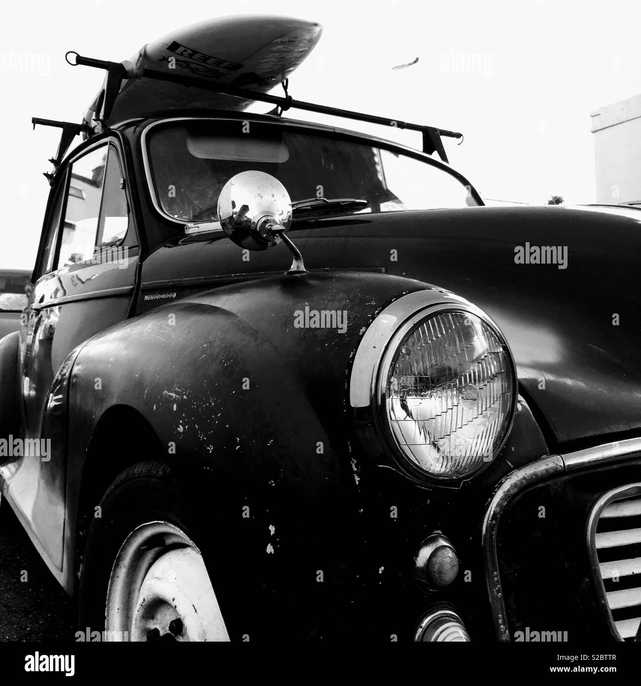 An old Morris minor 1000 ready hit the beaches with a surfboard on the ...