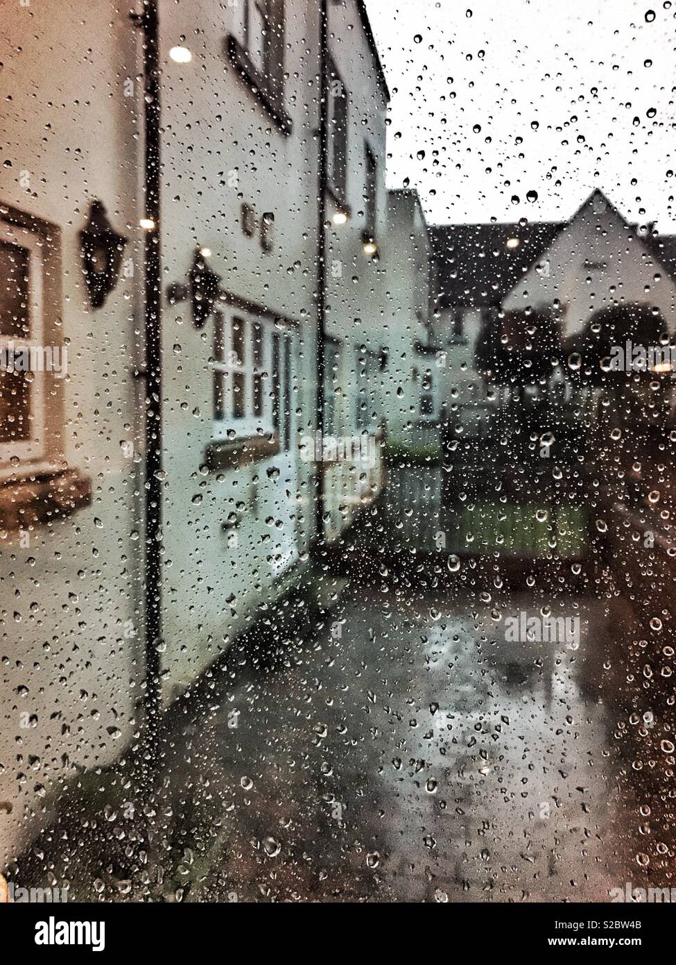 Looking out of the window in the pouring rain, with raindrops on the ...