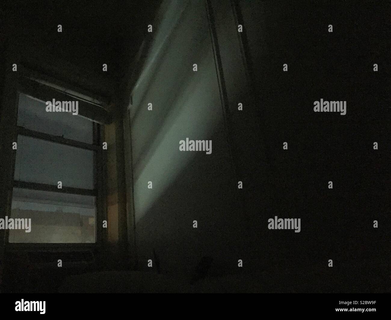 Dim light streaming through a window Stock Photo - Alamy