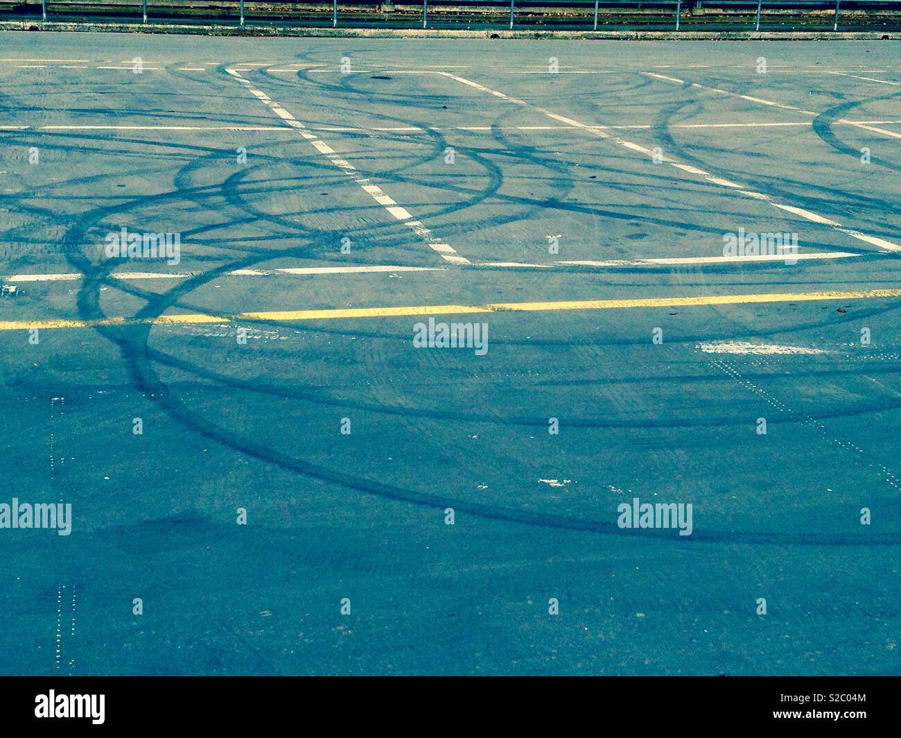 Vehicle tyre marks on car park road surface Stock Photo - Alamy