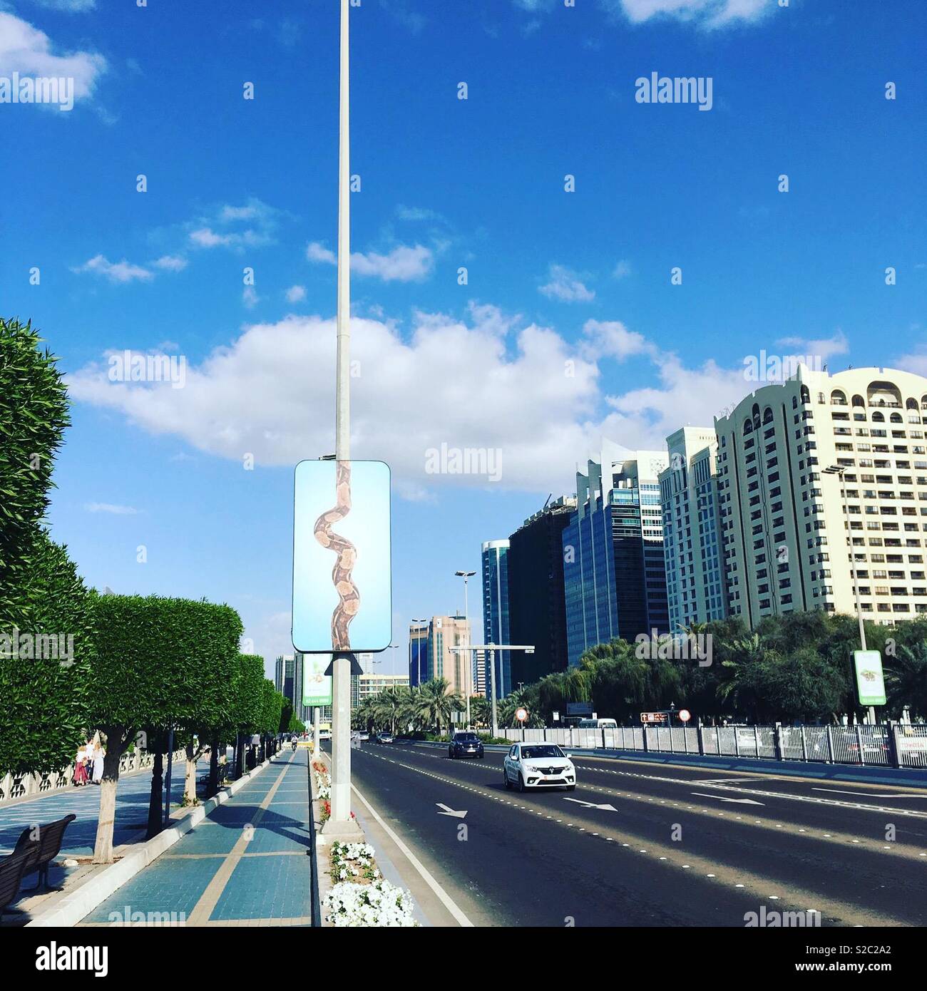 Unique snake signboard at roadside Stock Photo - Alamy