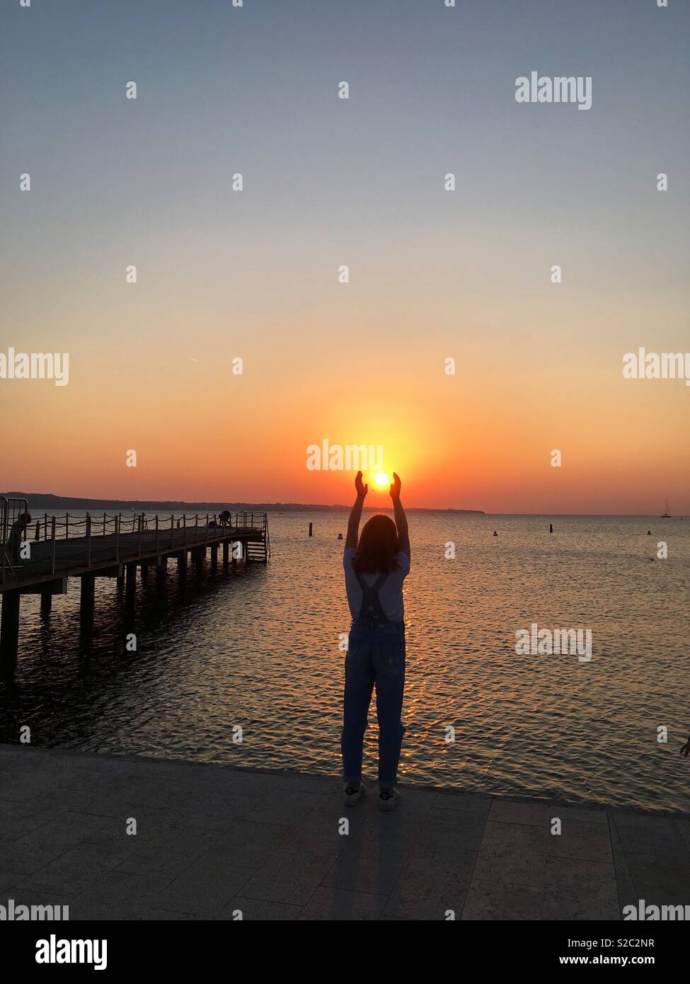 Girl holding the sun Stock Photo - Alamy
