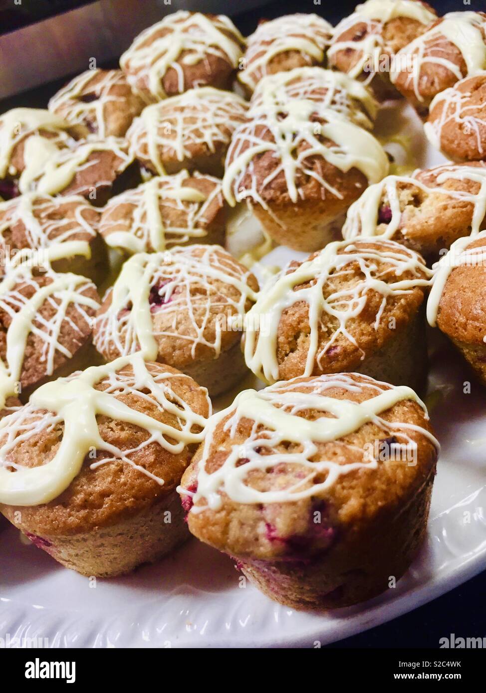Raspberry white choc muffins Stock Photo - Alamy