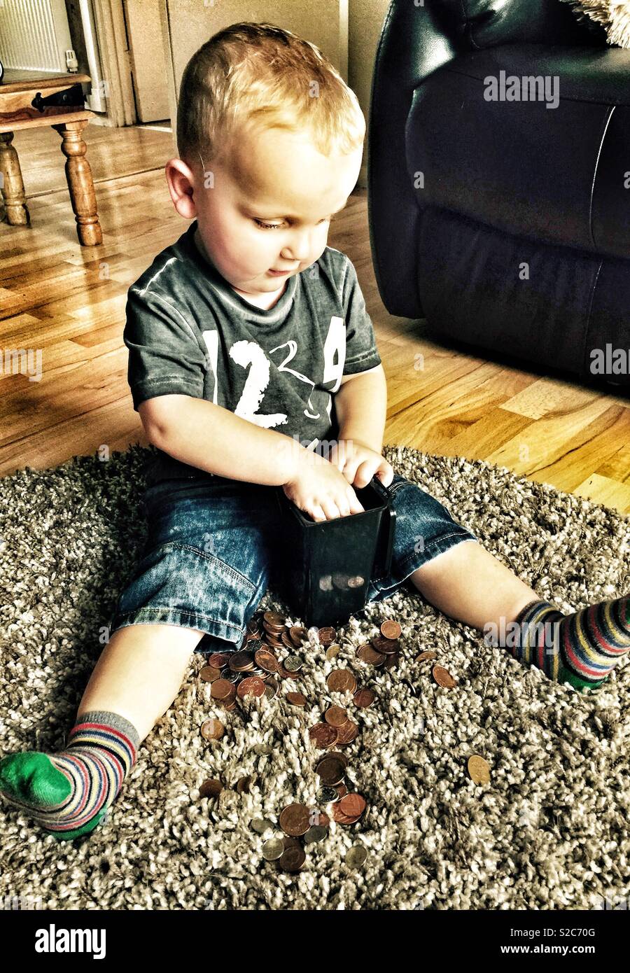 Little boy counting all of his money Stock Photo - Alamy