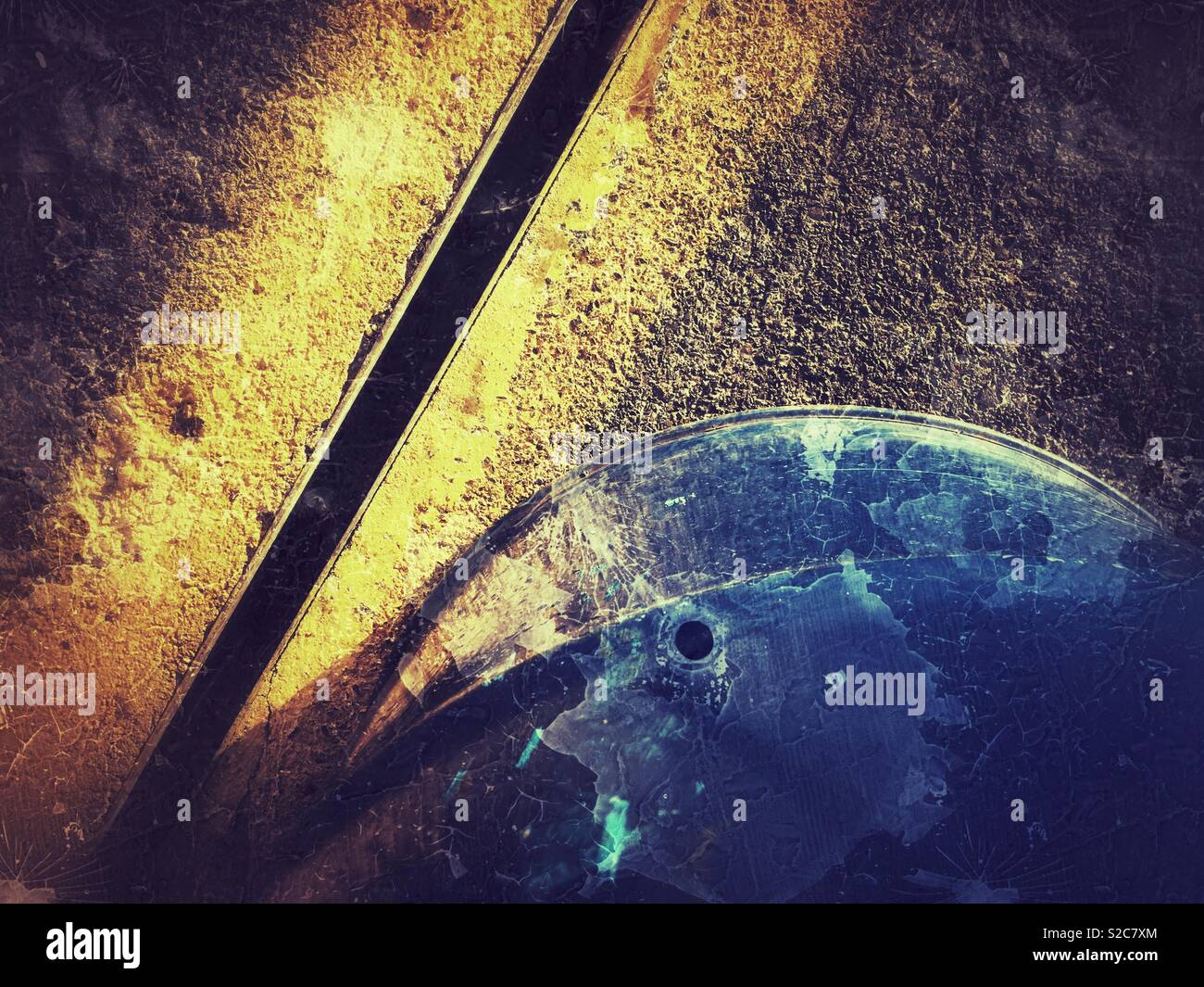 Grunge Effect Image Of The Bottom Edge Of A Blue Metal Barrel Standing grunge-effect-image-of-the-bottom-edge-of-a-blue-metal-barrel-standing
