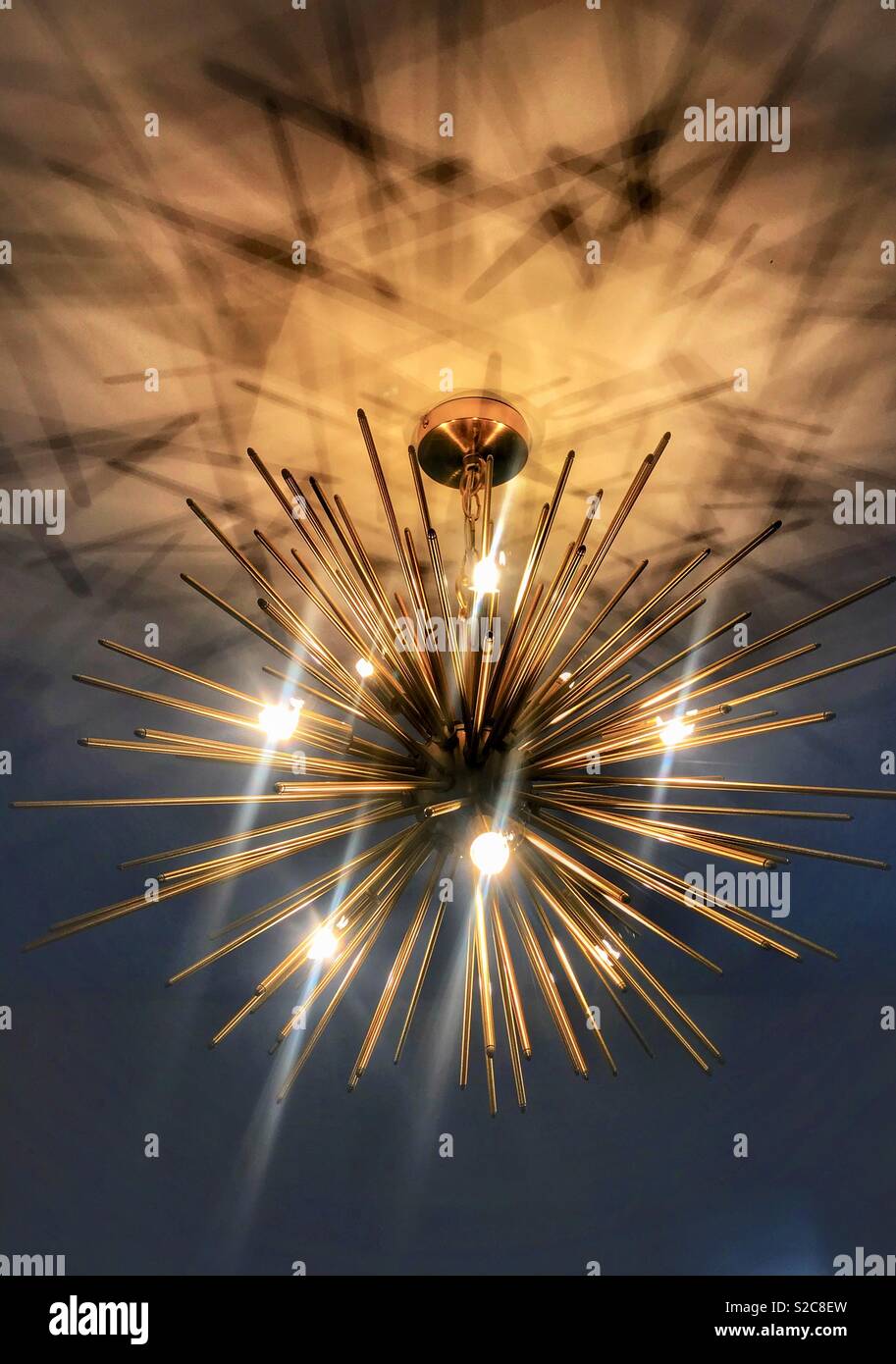 A modern ceiling light casts shadows on a ceiling Stock Photo - Alamy